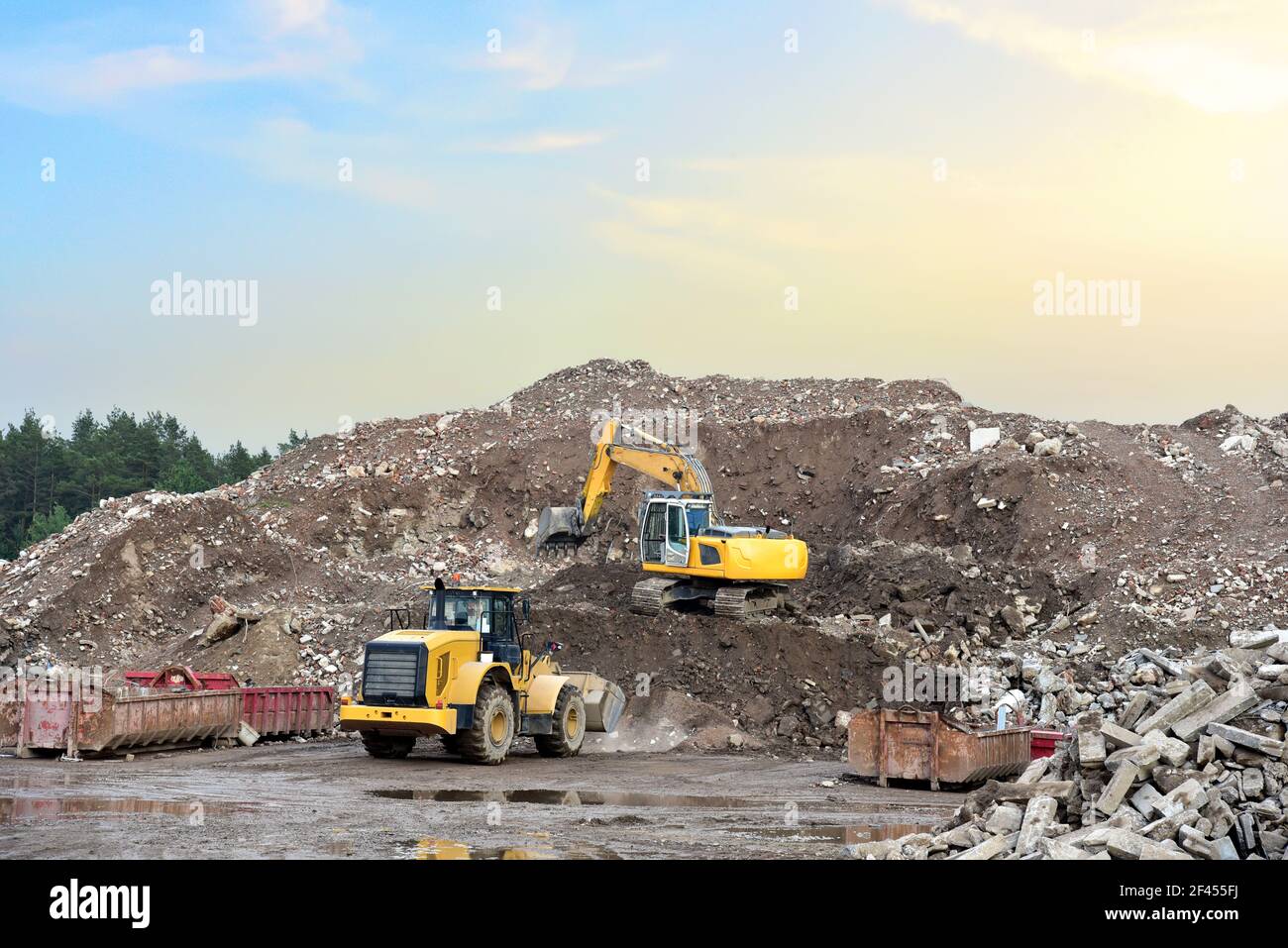 Recycling concrete and construction waste from demolition. Excavator ...