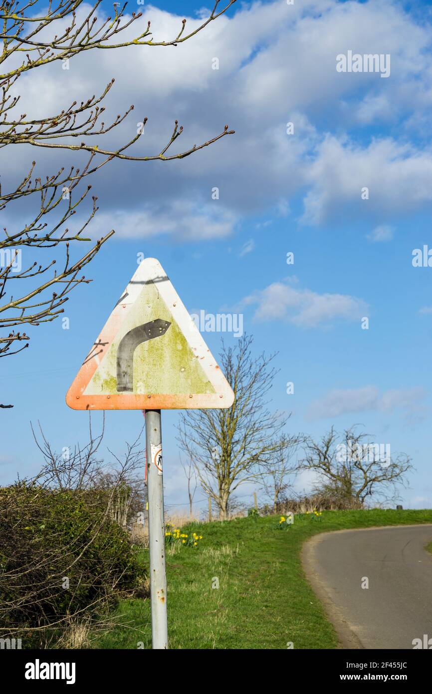Weathered road sign advising right hand bend hi-res stock photography ...