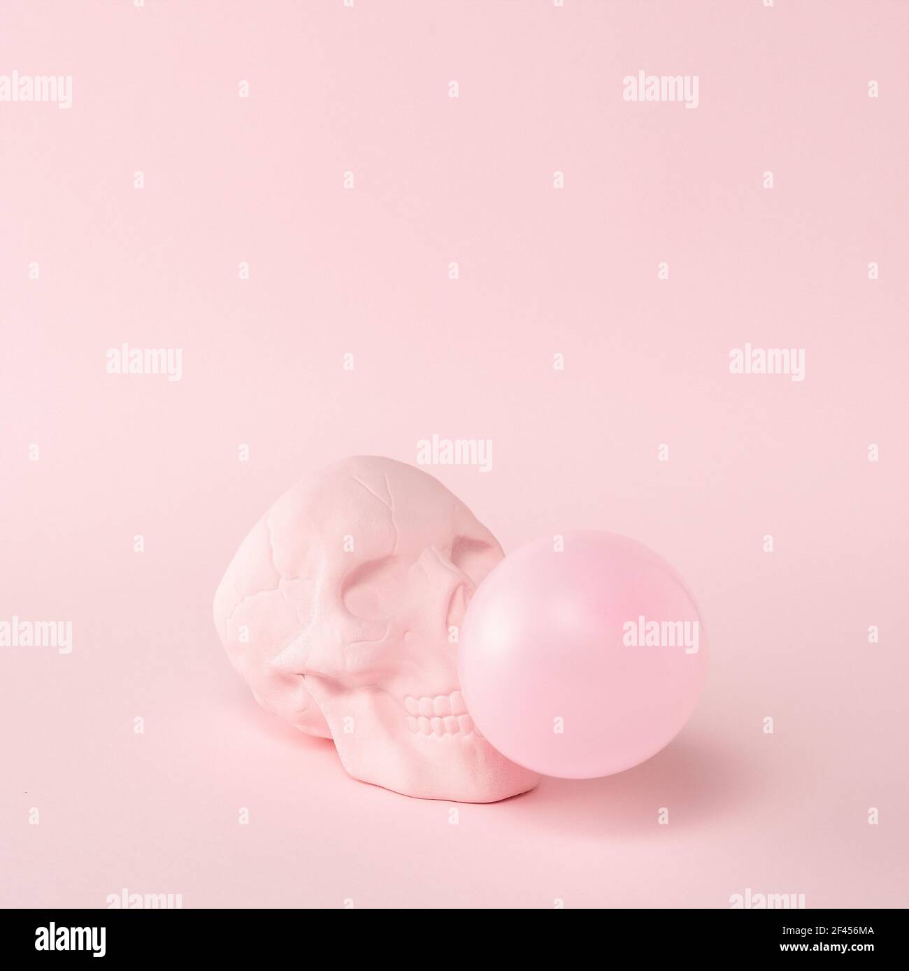 Pink skull with bubble gum on a pink background. Minimal Halloween ...