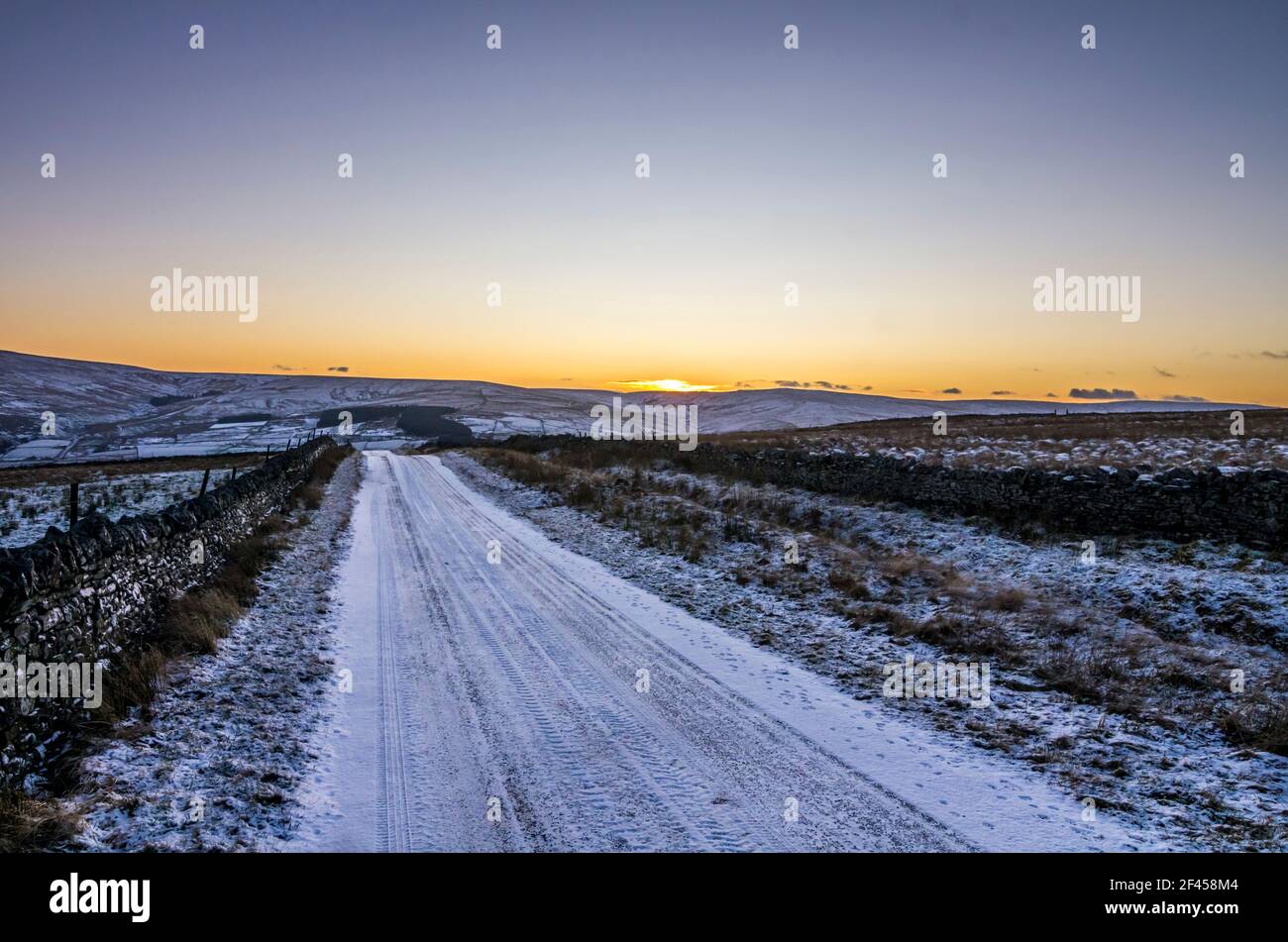 A high, remote, snow covered road at sunset (Weardale, the North ...