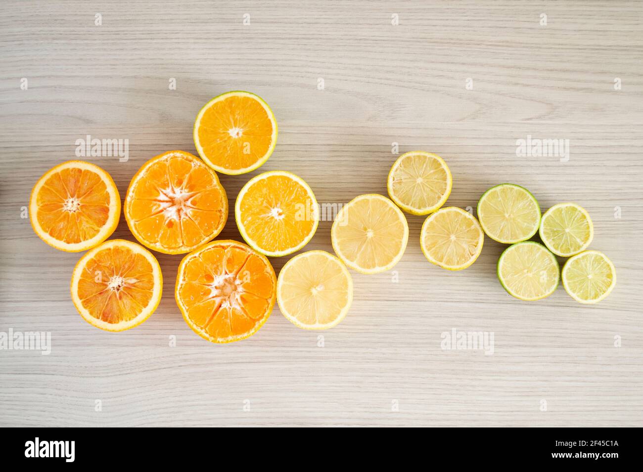 Citric fruit halves over wood background Stock Photo - Alamy