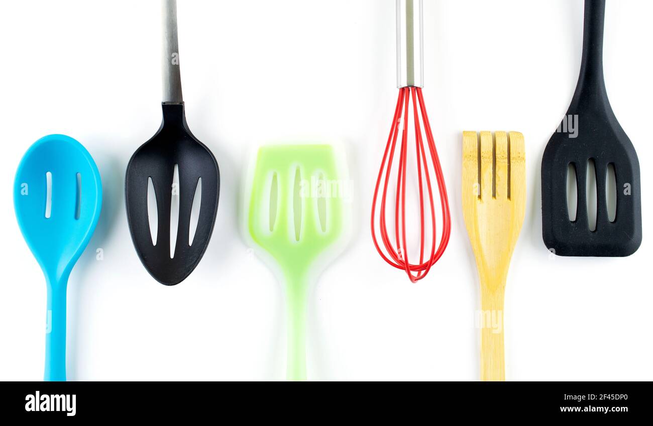 Colorful kitchen utensils over white background Stock Photo - Alamy