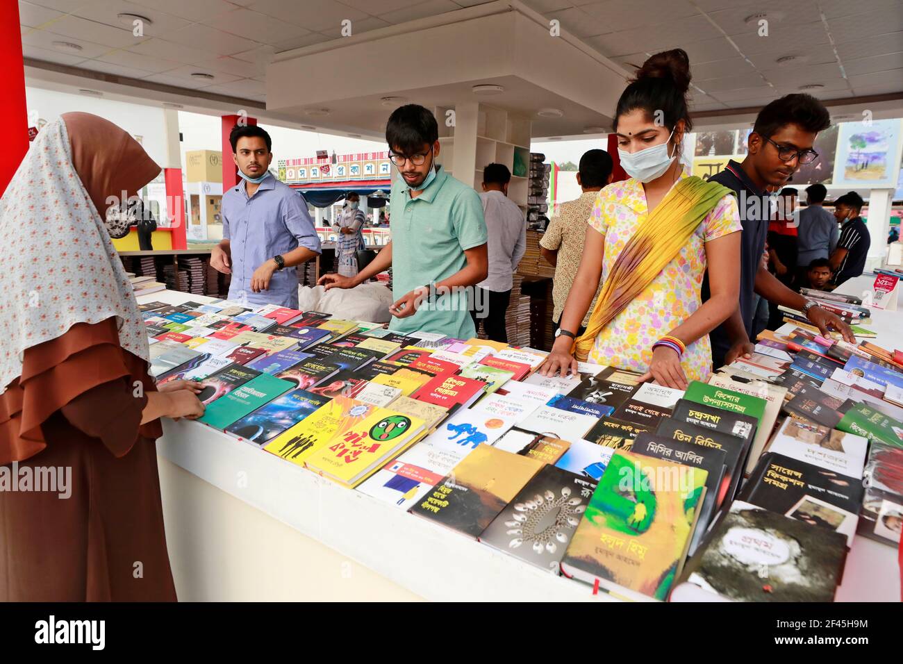 Dhaka, Bangladesh - March 18, 2021: Visitors browse books at a stall of ...