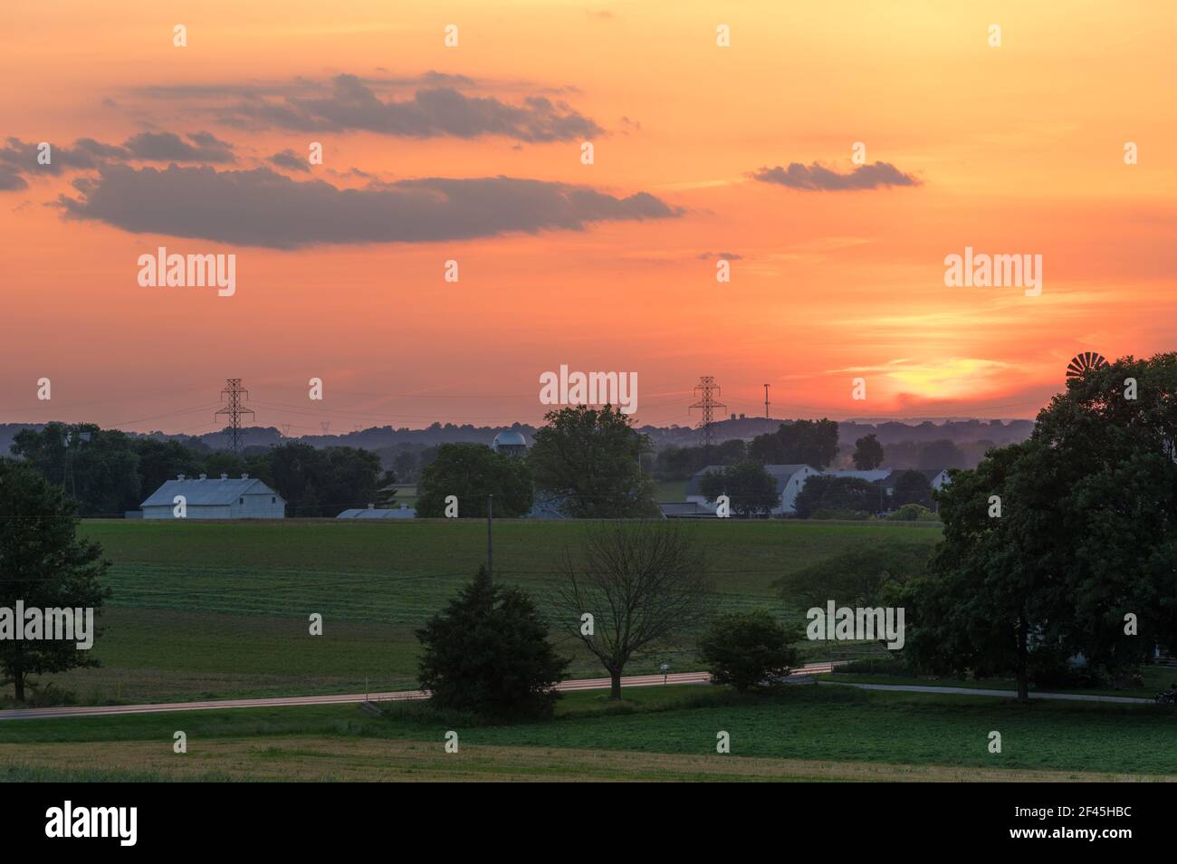 A landscape of an Amish farm during a beautiful sunset in Lancaster ...