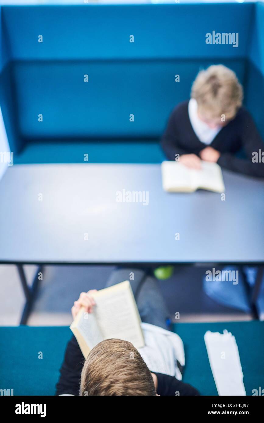 students reading a book in class in school Stock Photo - Alamy