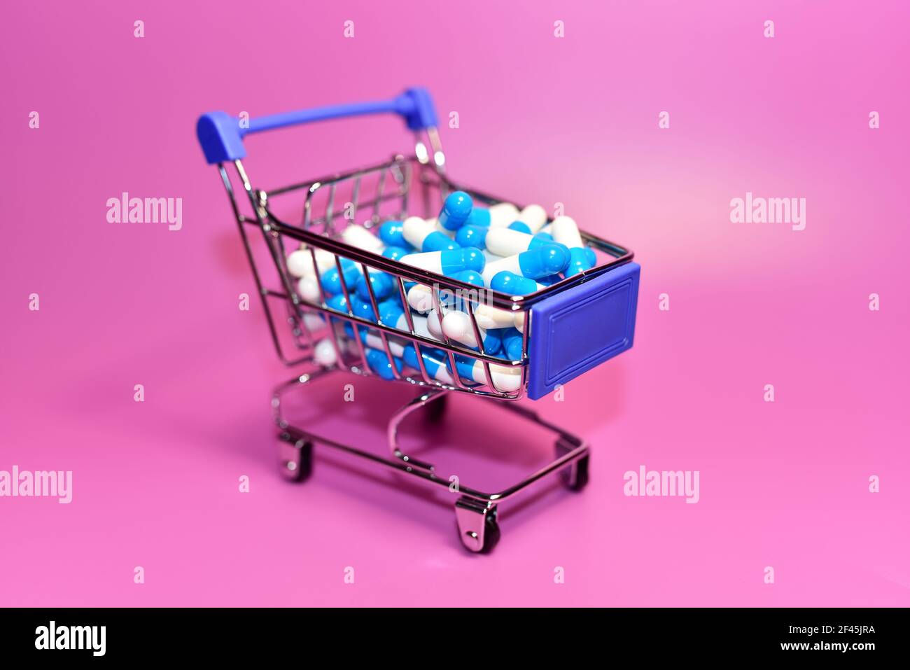 Pills in capsules and shopping cart. Medicine grade pharmaceutical ...