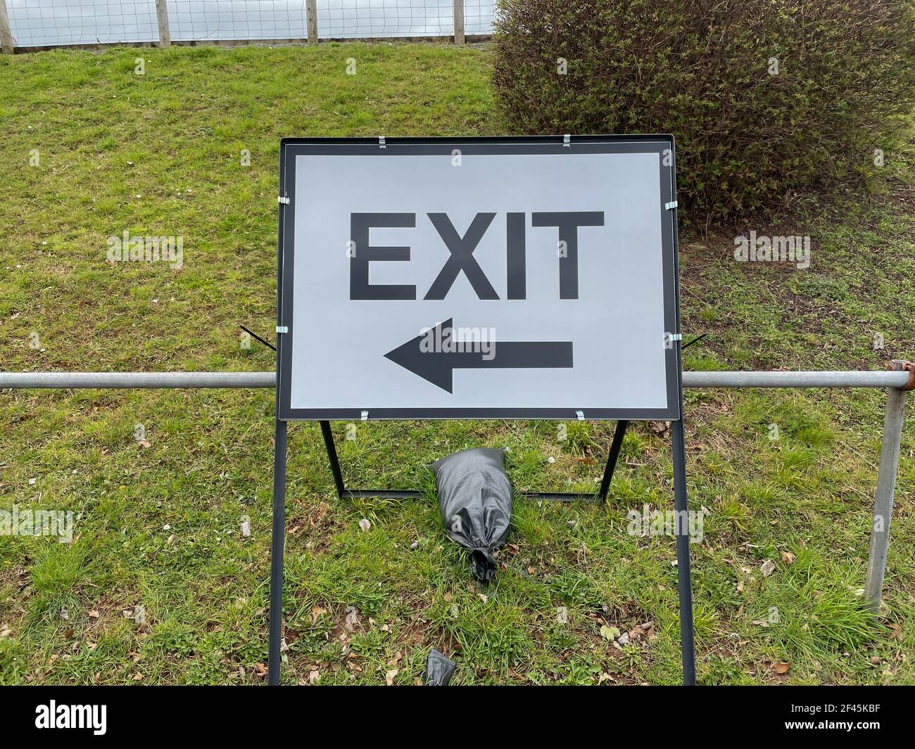 Free Standing Metal Exit Sign Weighed Down by Sandbags by a Grass Bank ...