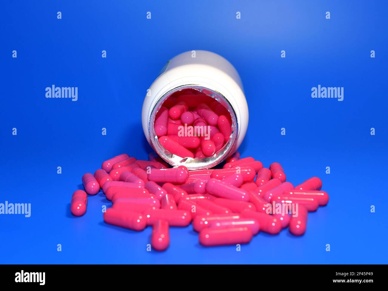 Pills from a bottle on blue background. Assorted pharmaceutical pills ...