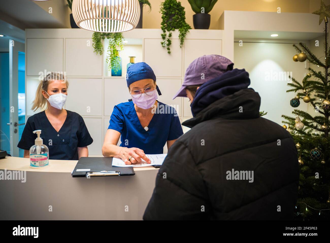 Dentist with a patient at the reception of her dental clinic Stock ...