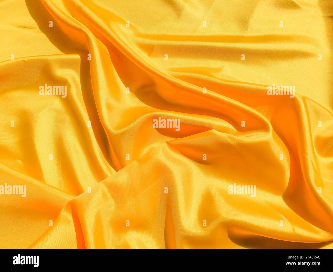 Beautiful yellow silk or satin texture background with copy space for ...