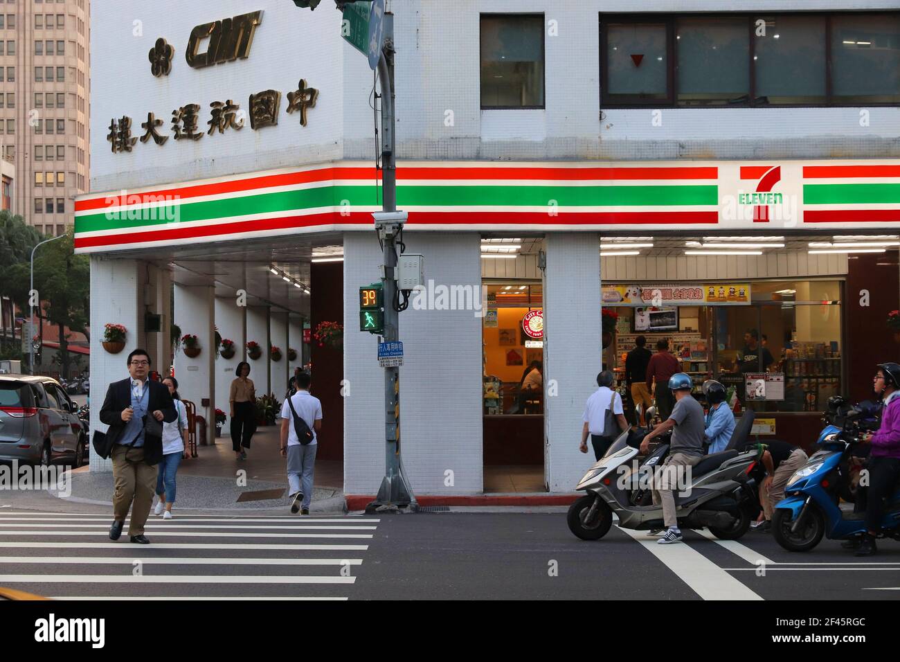 TAIPEI, TAIWAN - DECEMBER 3, 2018: People walk by 7-Eleven convenience ...