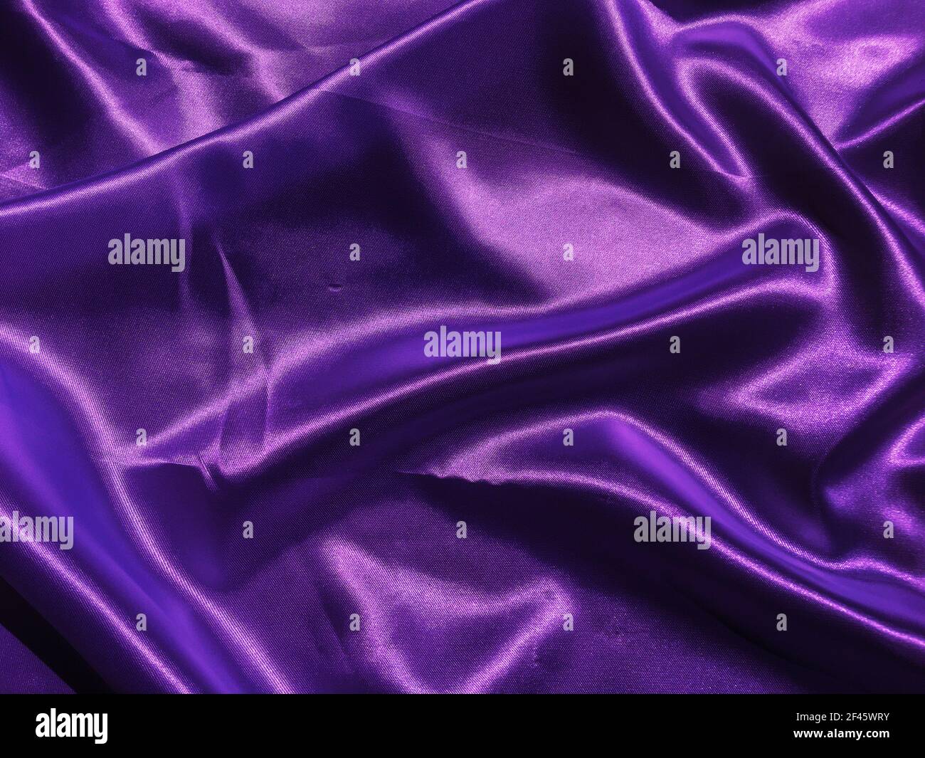 Beautiful smooth purple fabric texture background with copy space for ...