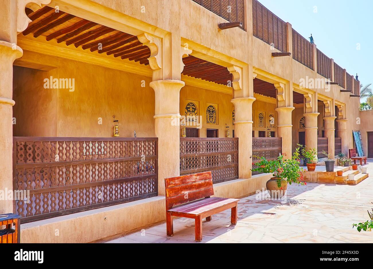 The beautiful adobe terrace with carved columns of the traditional ...