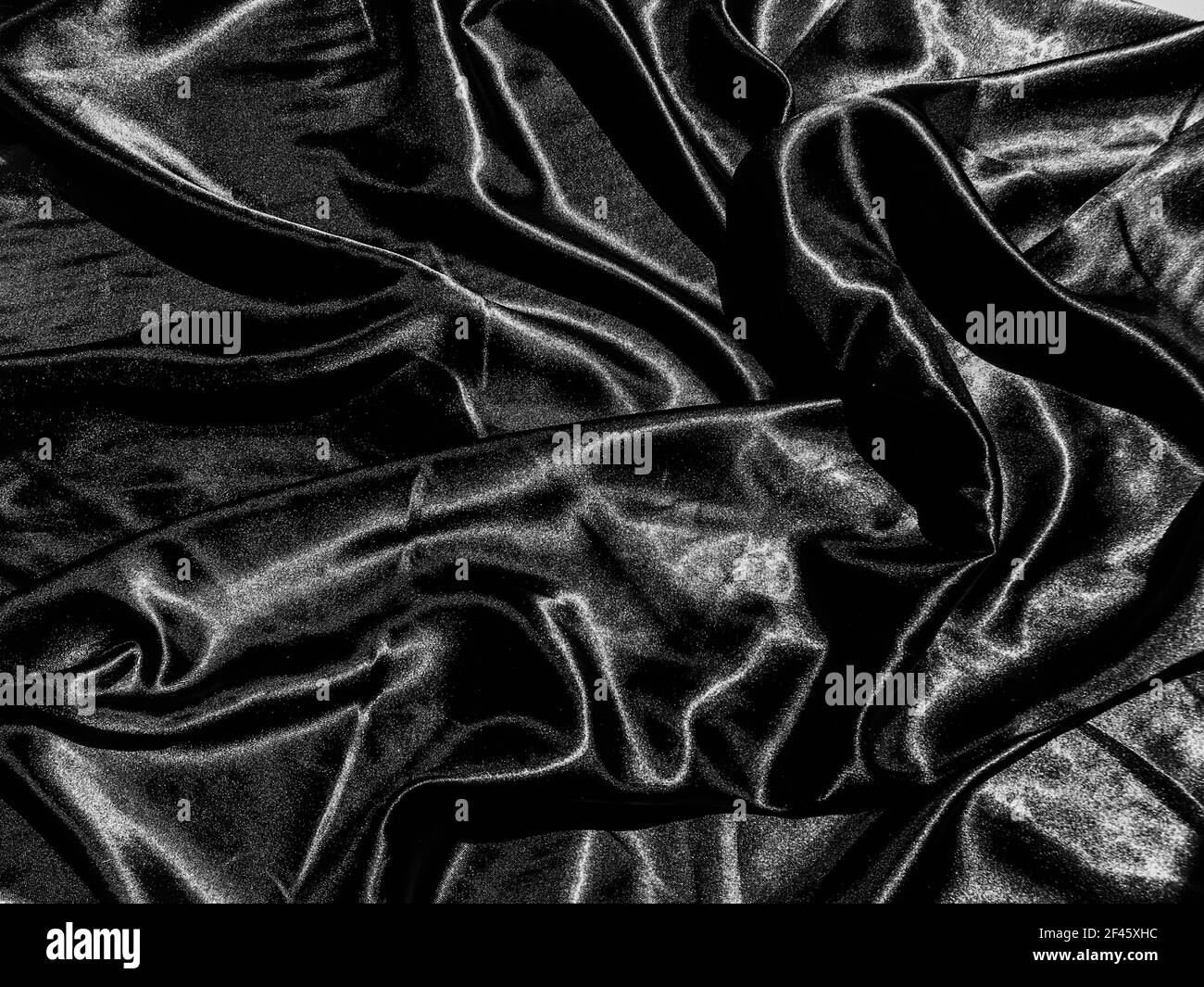 Black cloth or fabric texture background with liquid wave or wavy folds ...