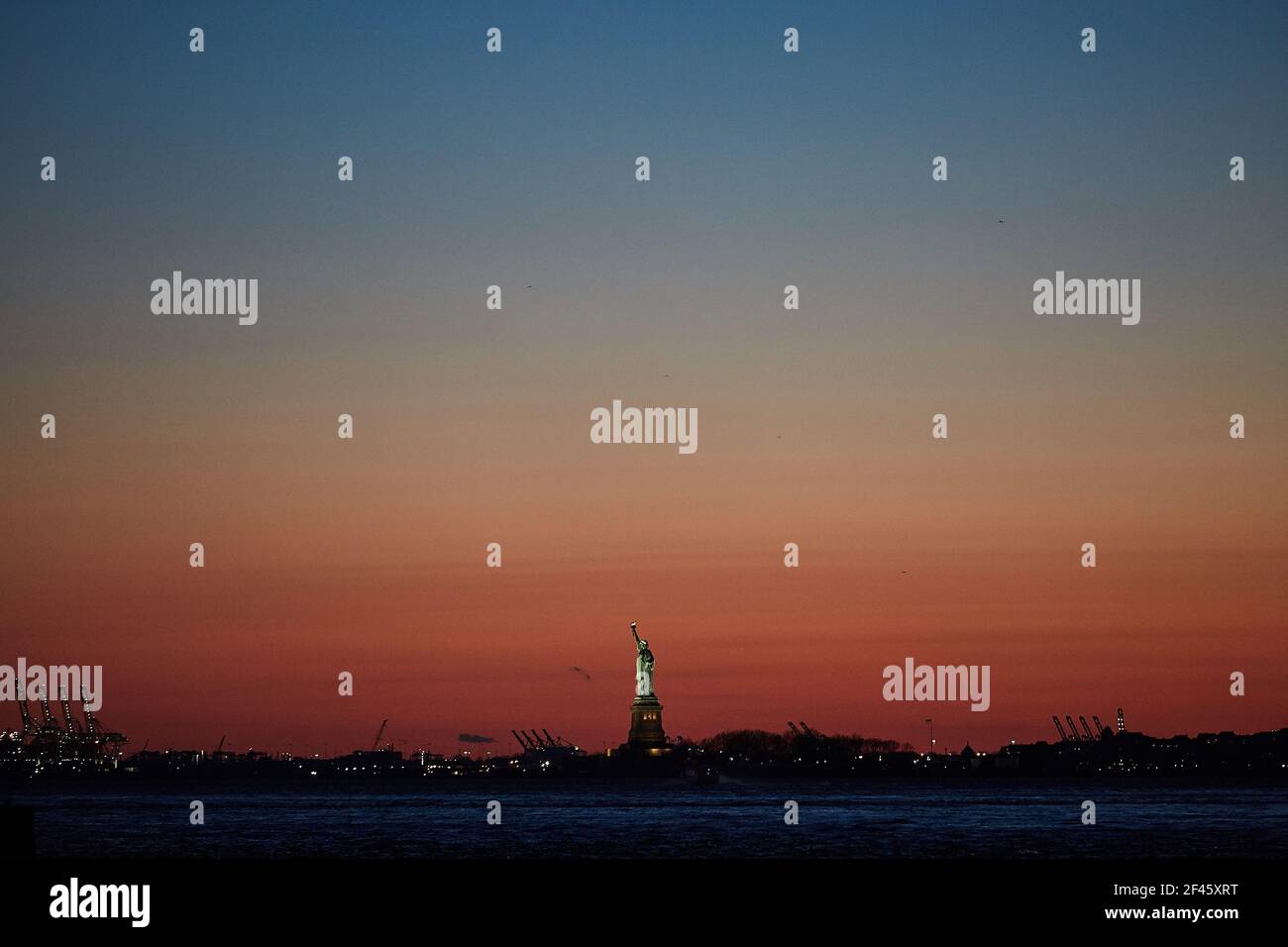 beautiful red sunset behind the statue of liberty Stock Photo - Alamy