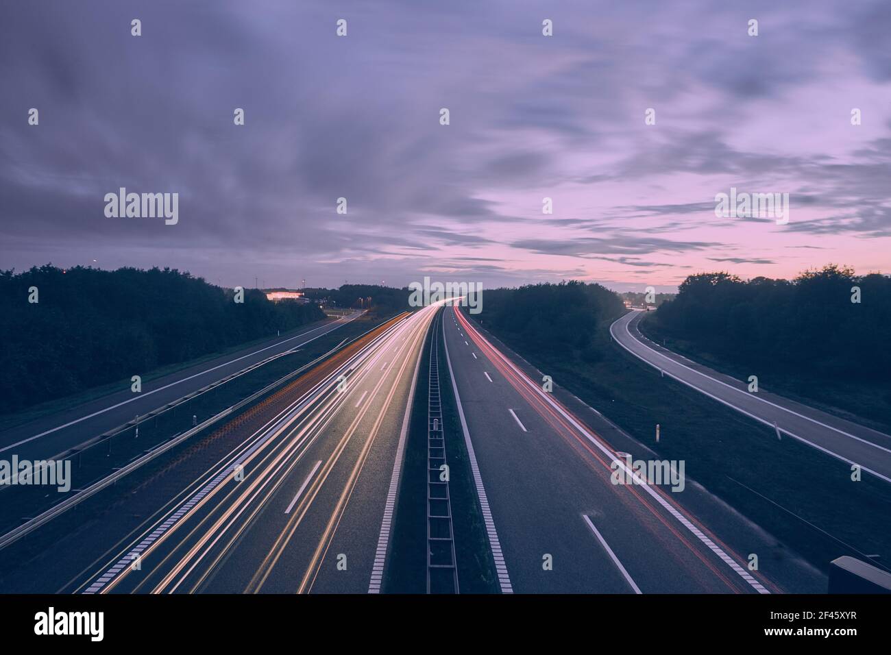 a view of highway at night with clouds Stock Photo - Alamy