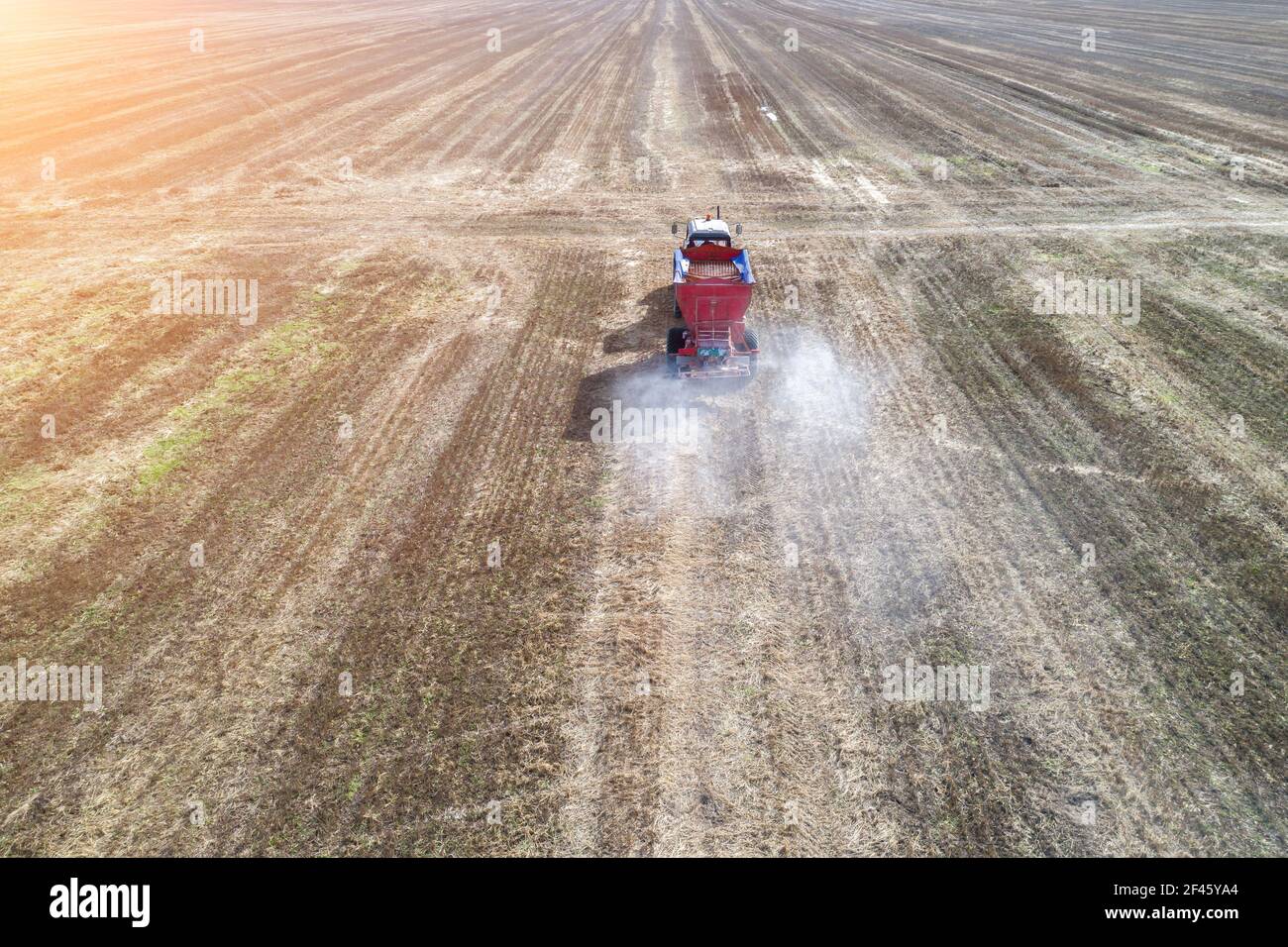 Tractor spreading artificial fertilizers in field Stock Photo - Alamy