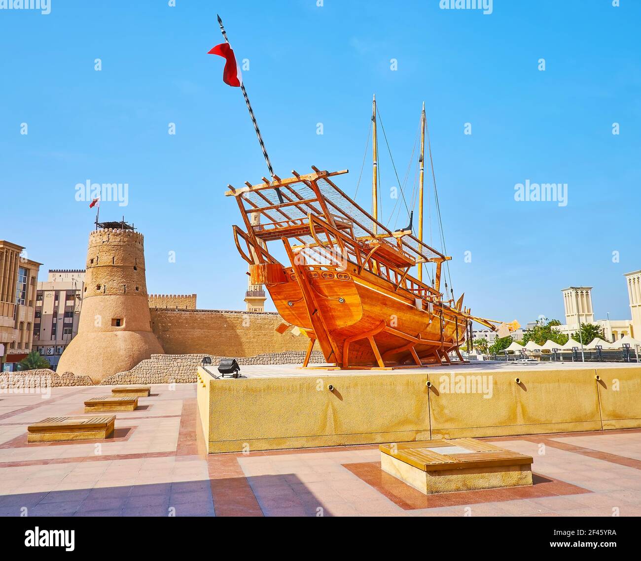 The traditional wooden dhow boat installation in front of the medieval ...