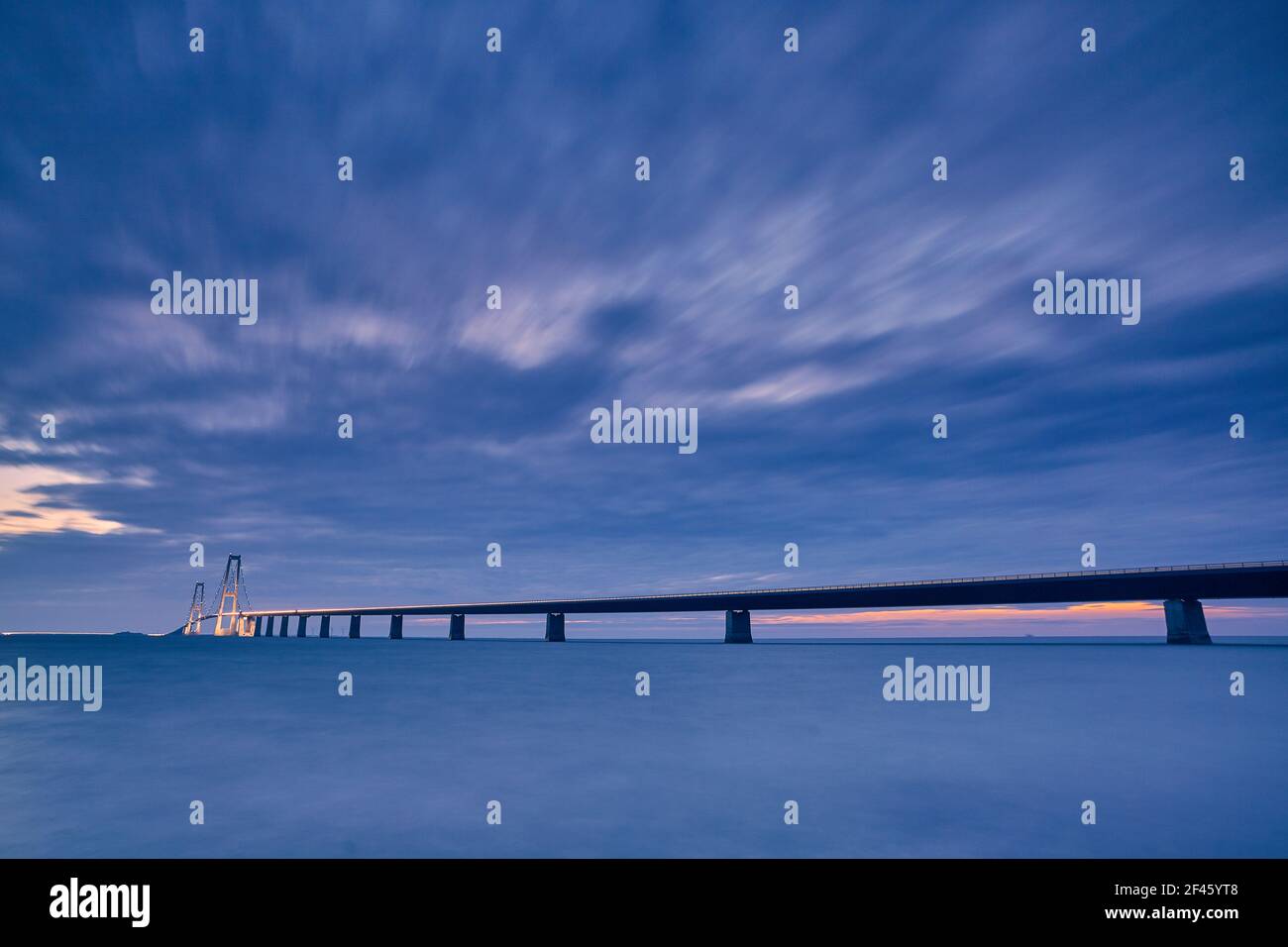 a long bridge at night with beautiful blue sunset Stock Photo - Alamy