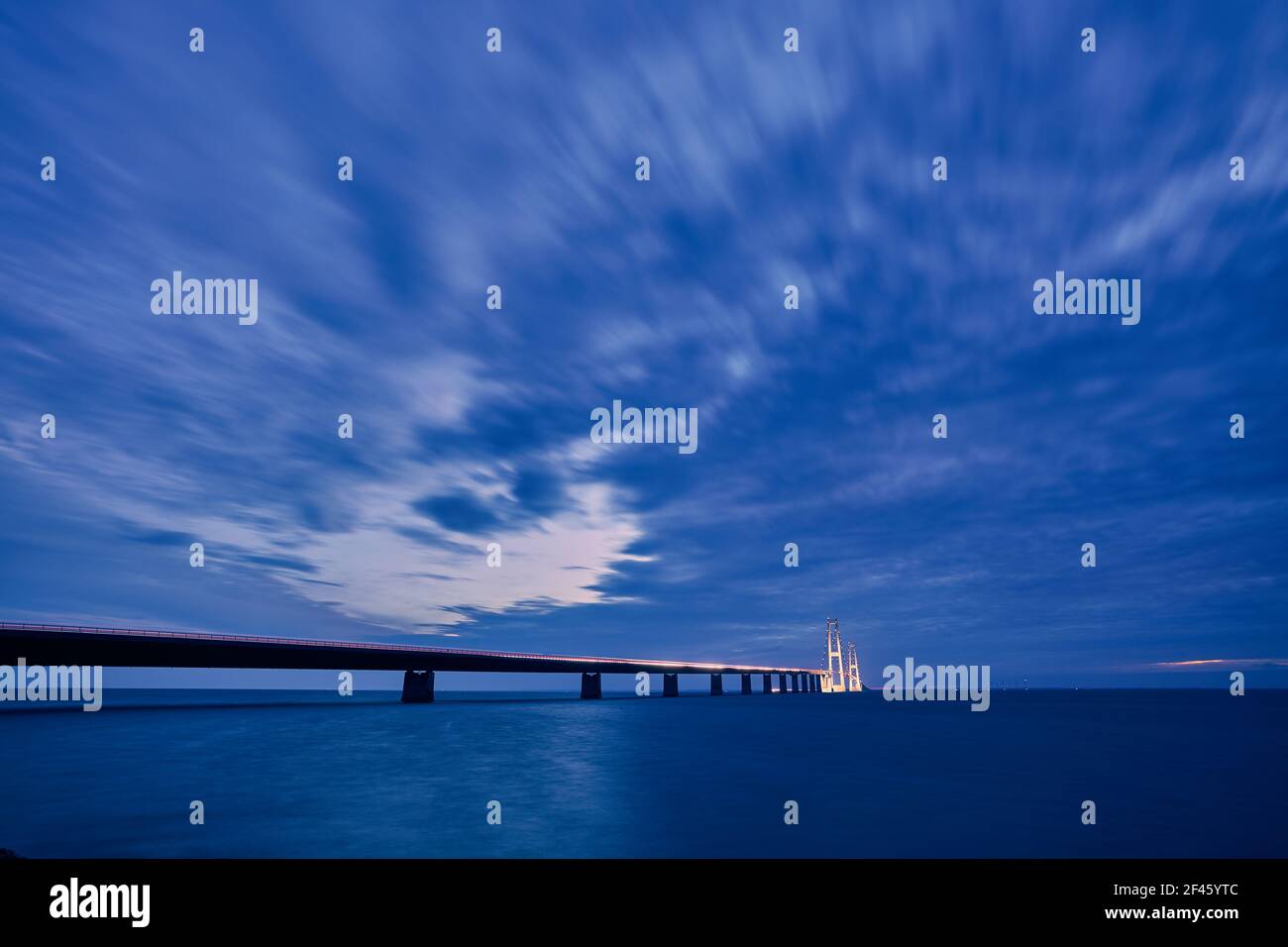 a long bridge at night with beautiful blue sunset Stock Photo - Alamy