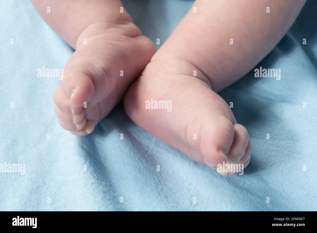Close up view of newborn baby legs on a bed Stock Photo - Alamy