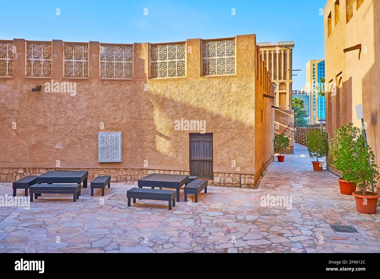 The benches in shady street in front of the scenic mansion, decorated ...