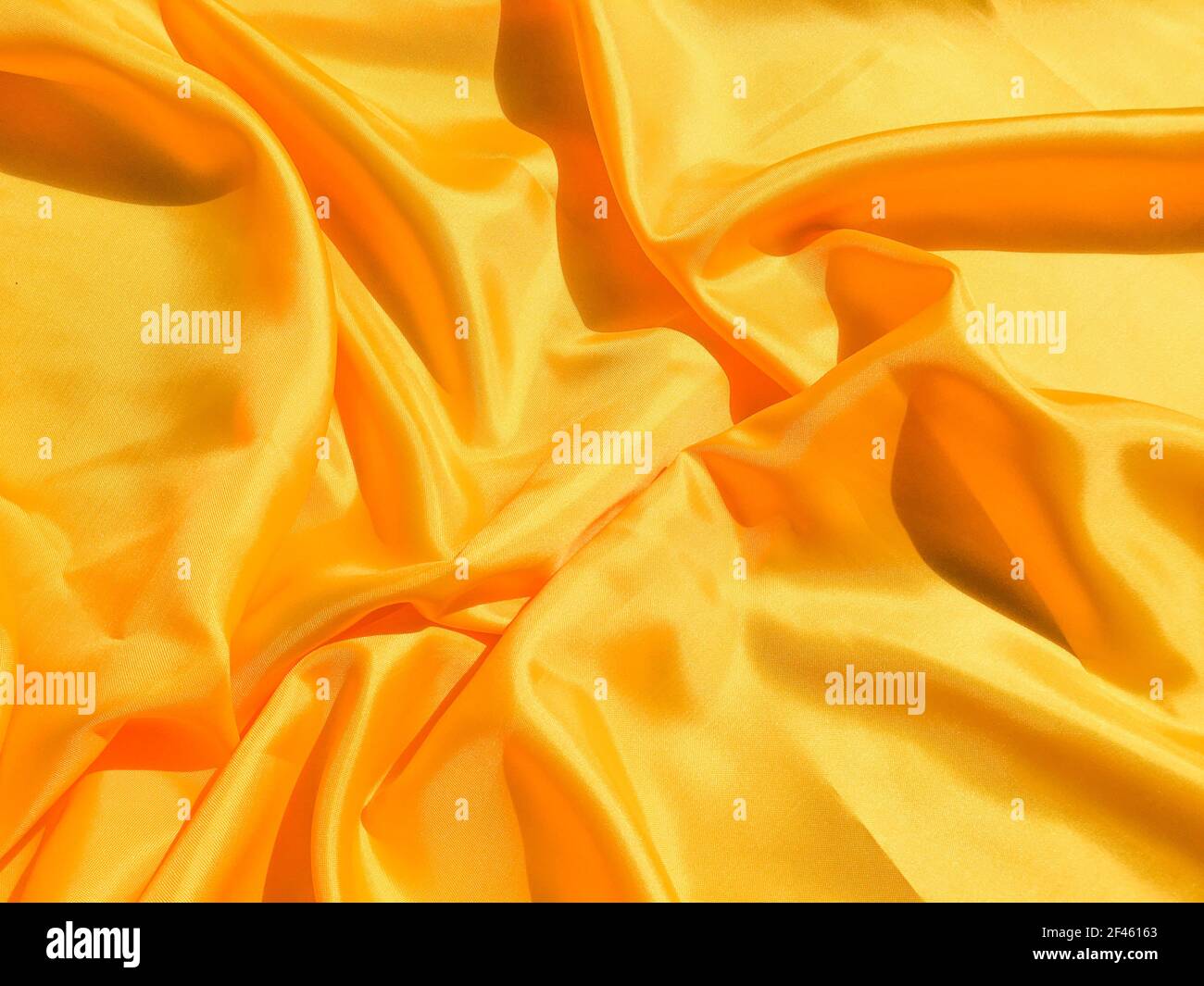 Bright yellow silk with waves moving for background. Abstract design ...