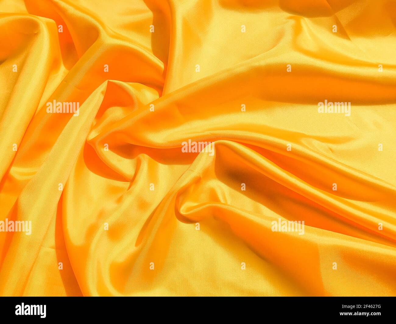 Bright yellow silk with waves moving for background. Abstract design ...