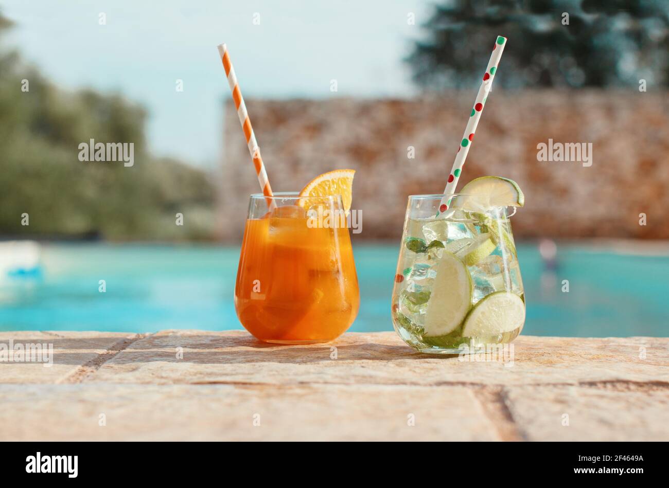 Two refreshing cocktails near a swimming pool closeup Stock Photo - Alamy