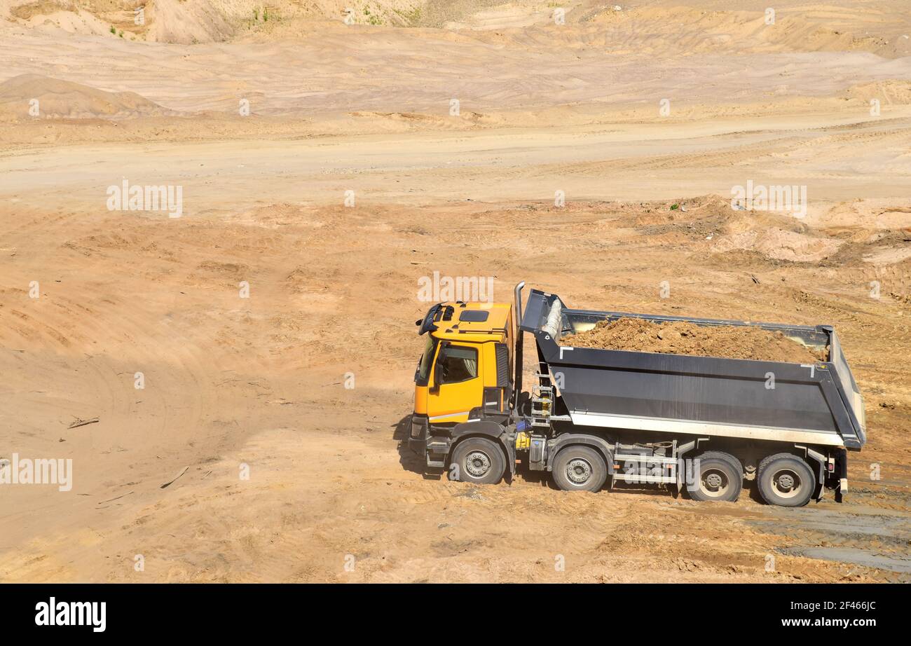 Dump truck transports sand in open pit mine. In the production of ...