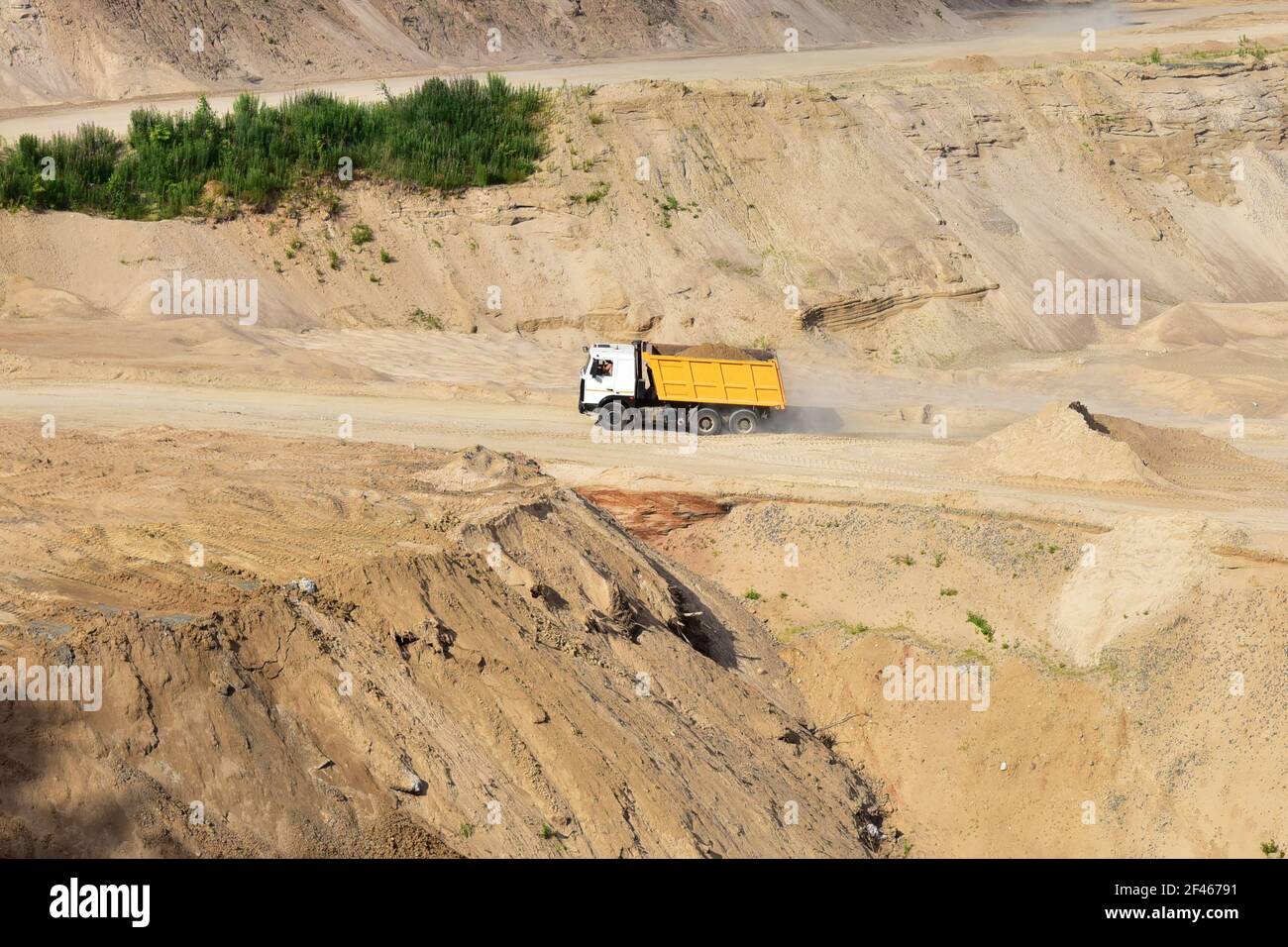 Dump truck transports sand in open pit mine. In the production of ...
