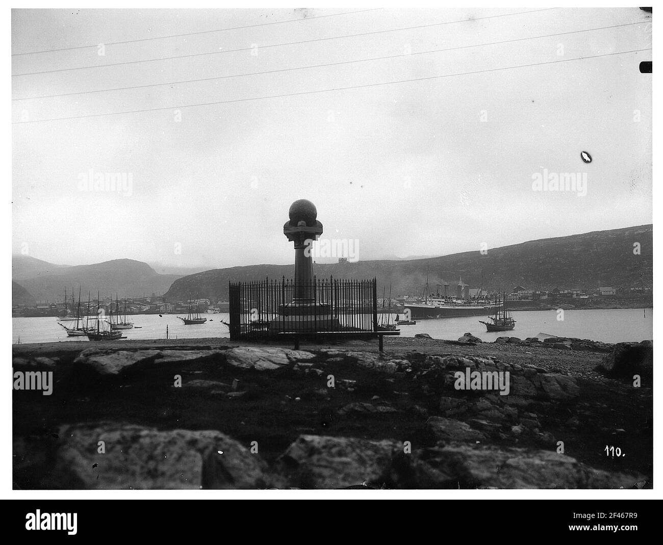 Meridian column in the harbor of Hammerfest against bay with Victoria ...
