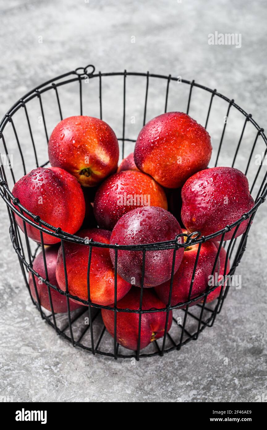 Fresh red nectarines in a steel basket. Gray background. Top view Stock ...