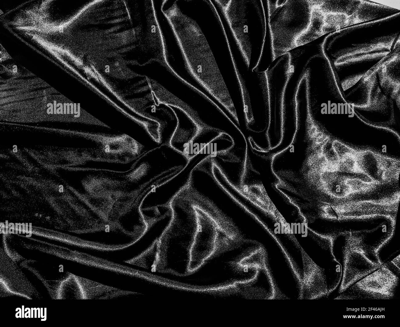 Black cloth or fabric texture background with liquid wave or wavy folds ...