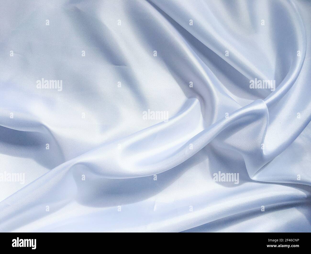 Solf white satin fabric texture background. use as wedding or ...