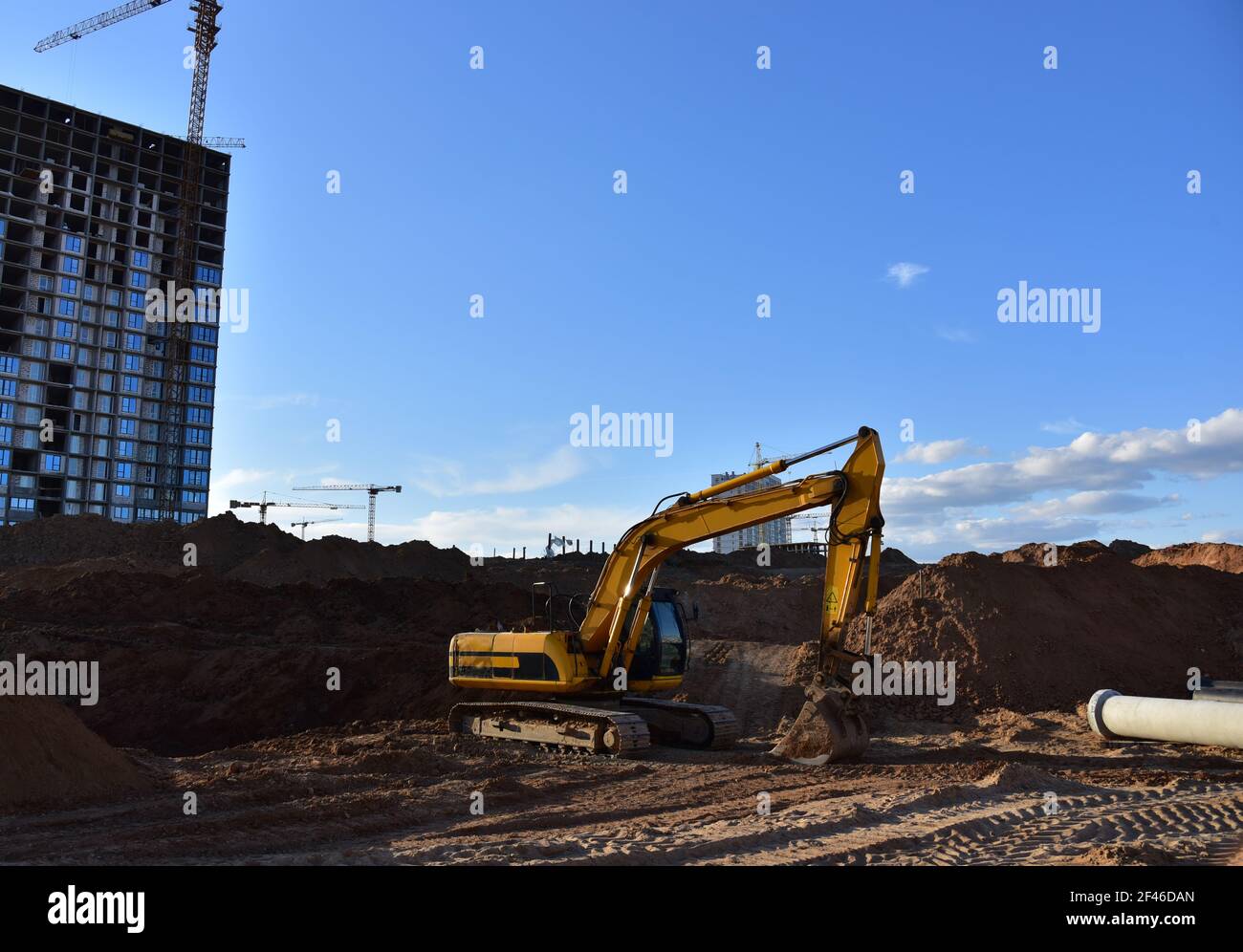 Excavator dig trench at construction site. Digging the pit foundation ...