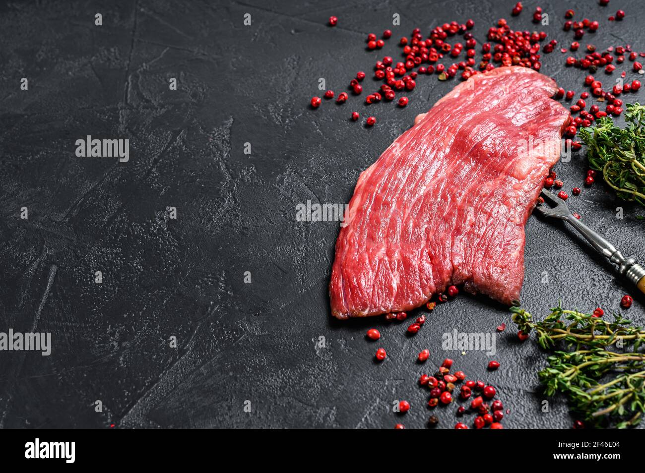 Raw Flank steak with rosemary and pink salt. Fresh Marble beef meat ...