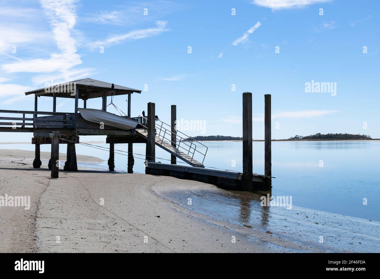 Private boat dock on Tybee Creek at the Atlantic Ocean, sandy beach and ...