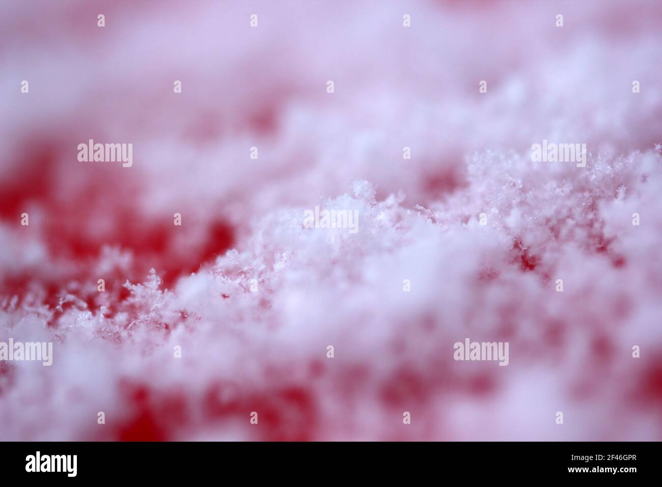 Snow on a red background Stock Photo - Alamy