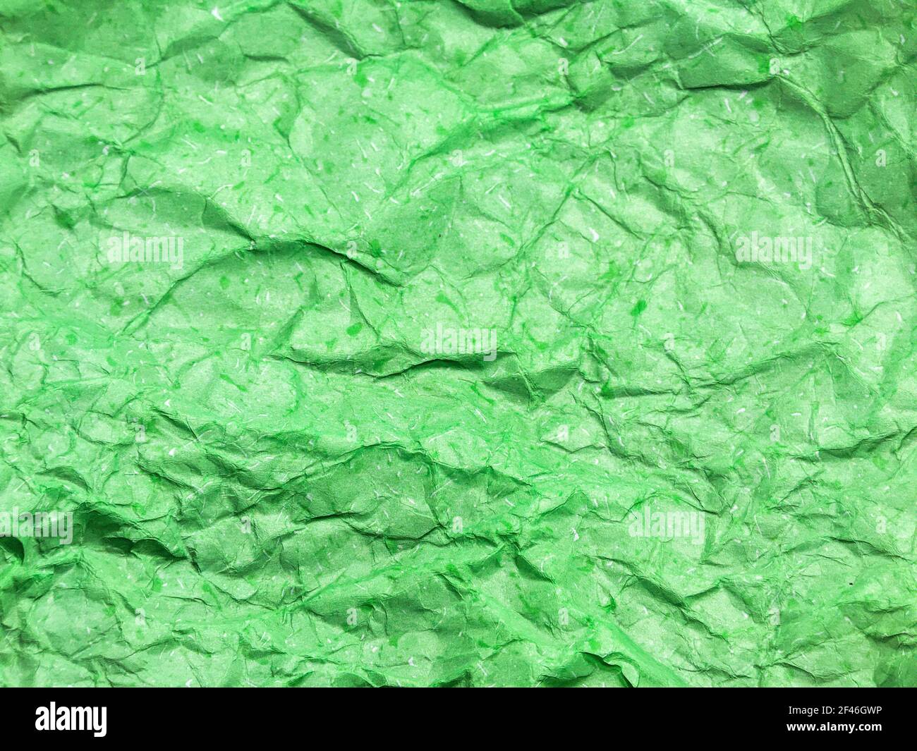 Pattern of green crumpled paper texture background Stock Photo - Alamy