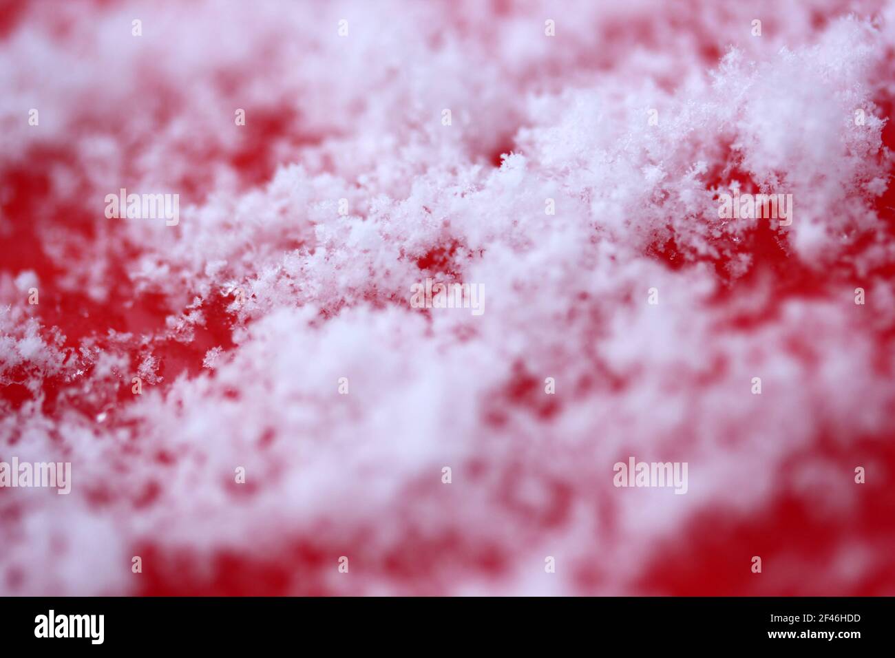Snow on a red background Stock Photo - Alamy