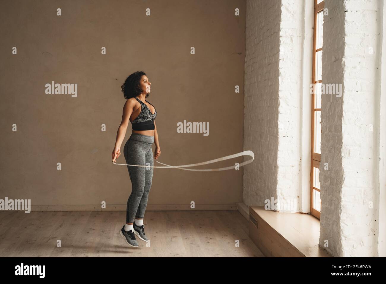 Woman is jumping rope, workout at health club. Sporty attractive female ...