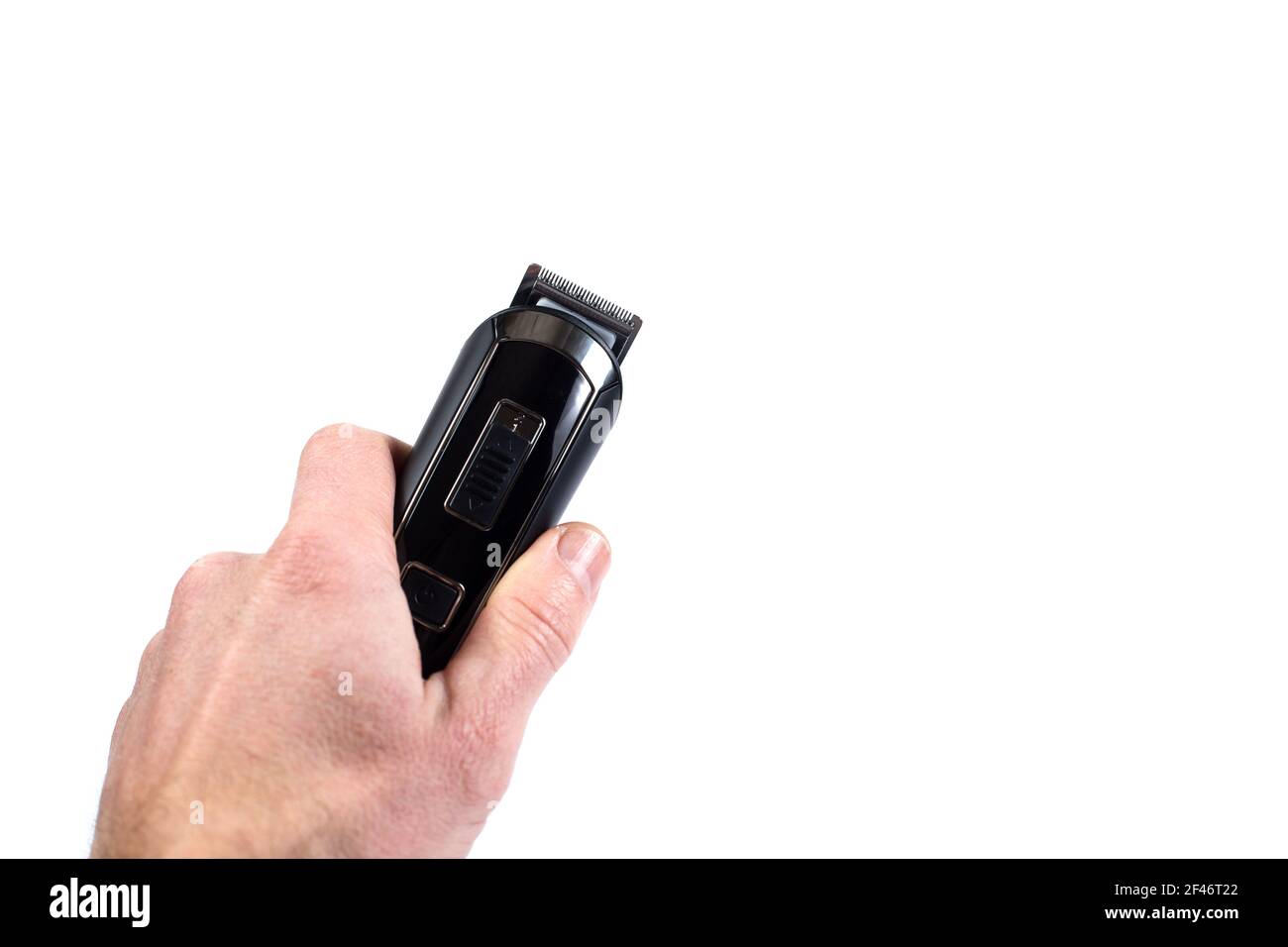 Male hand holding Shaving machine close up, isolated on a white with ...