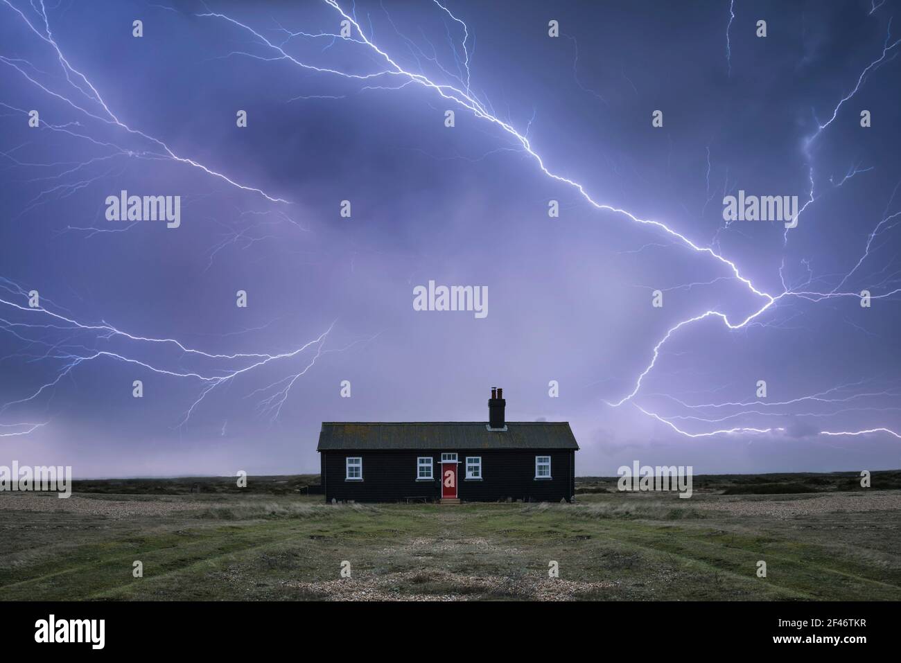 Remote desolate isolated house under dark stormy sky full of lightning ...