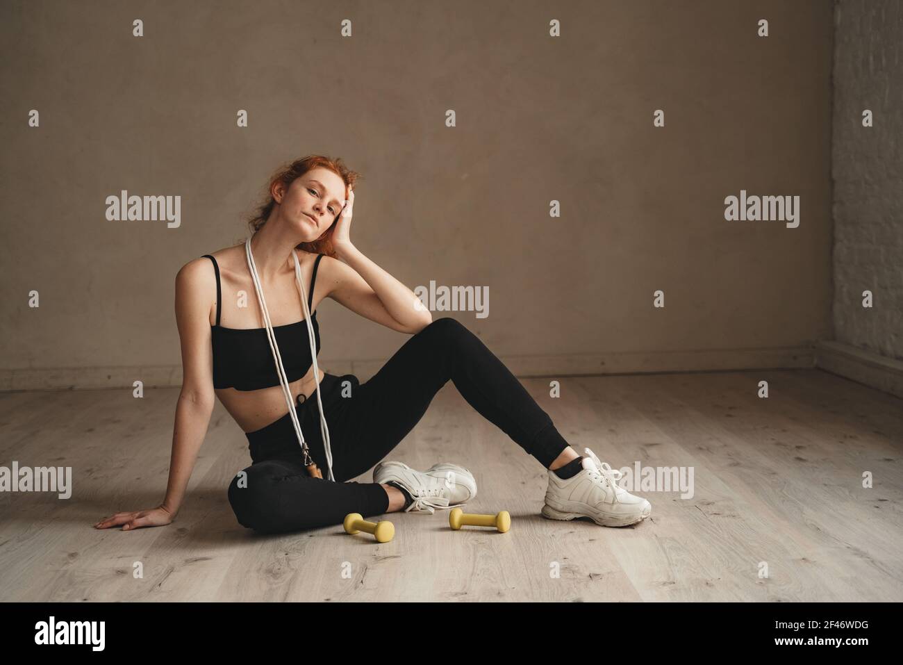 Fit athletic woman relaxing after workout at health club. Sporty ...