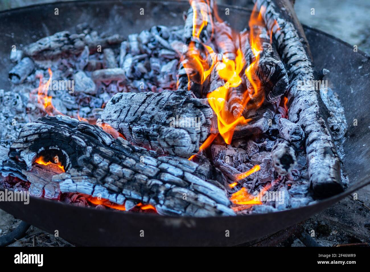 A burning fire in a pit, a lot of wood already burned away Stock Photo ...