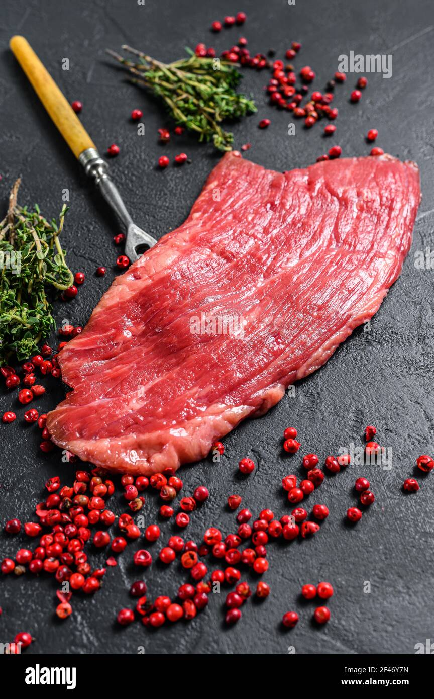 Raw Flank steak with rosemary and pink salt. Fresh Marble beef meat ...