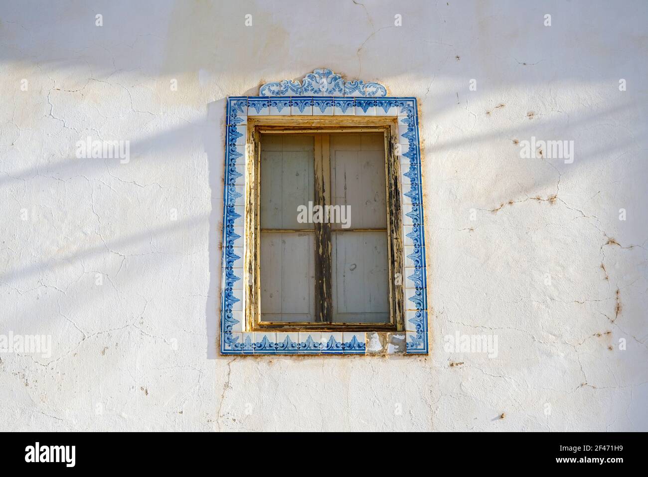 A window framed with white and blue ornamental ceramic tiles Stock ...