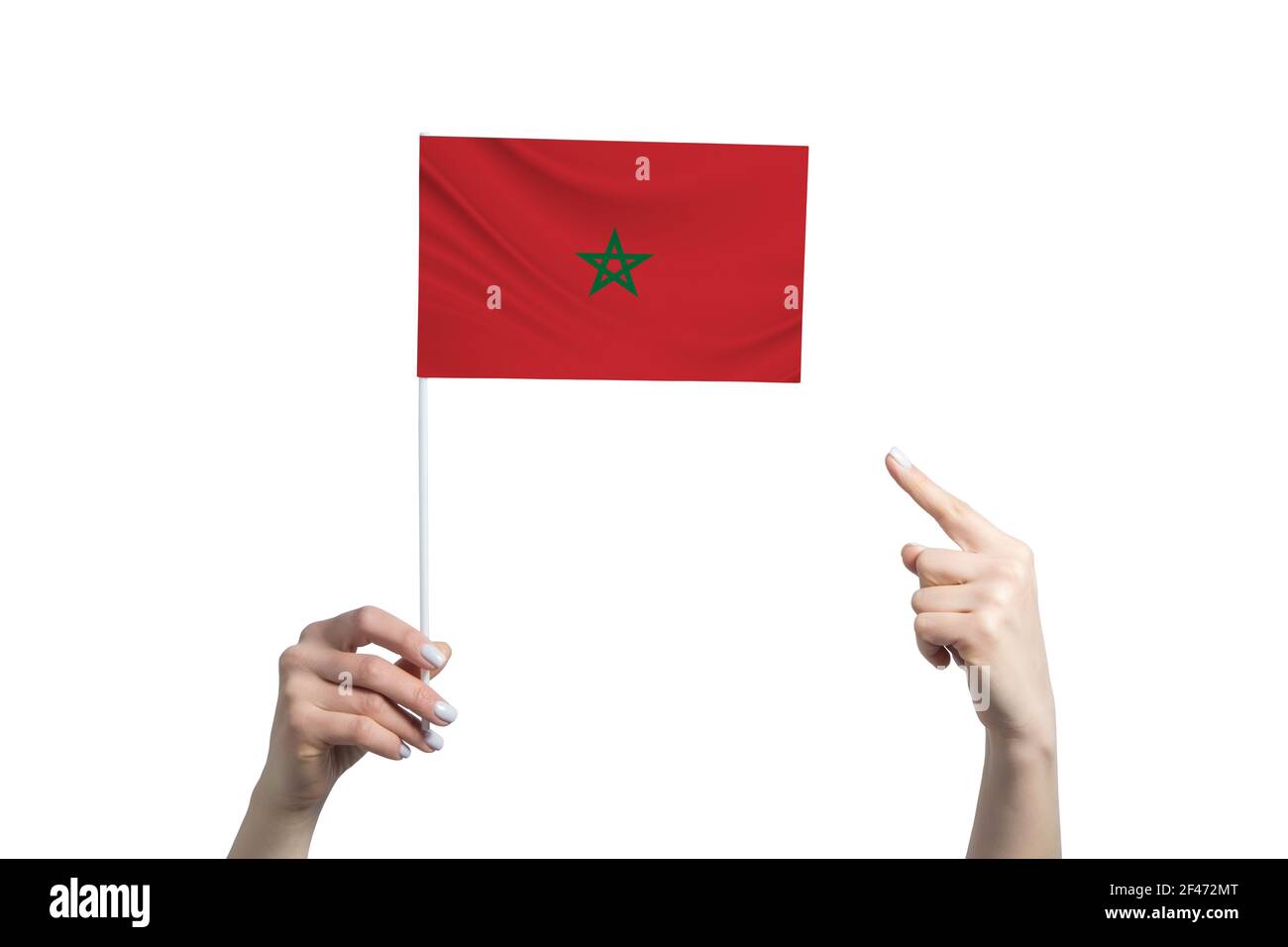 A beautiful female hand holds a Morocco flag to which she shows the ...