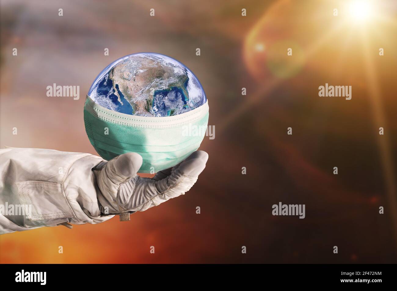 Planet Earth with face mask protect in astronaut hand. World medical ...